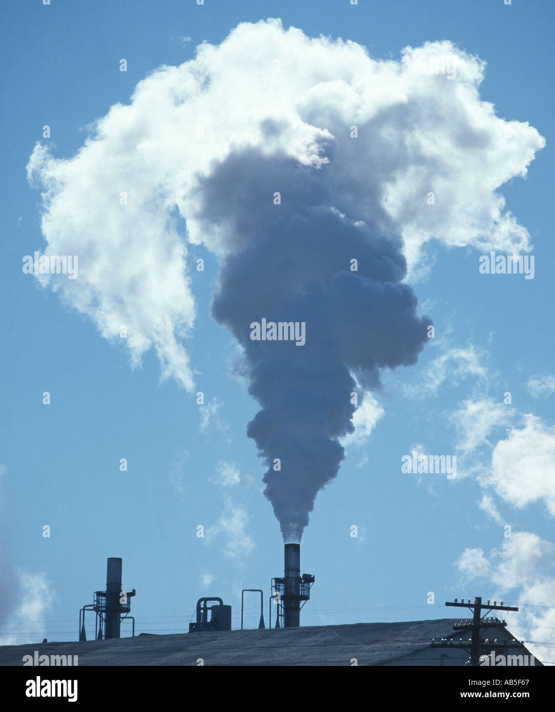 smoke pouring from chimney in industrial area Stock Photo - Alamy