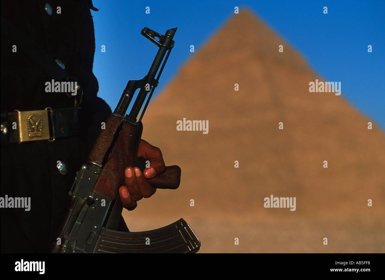 Egypt Cairo Soldier with gun guarding the tourists at the pyramids of ...