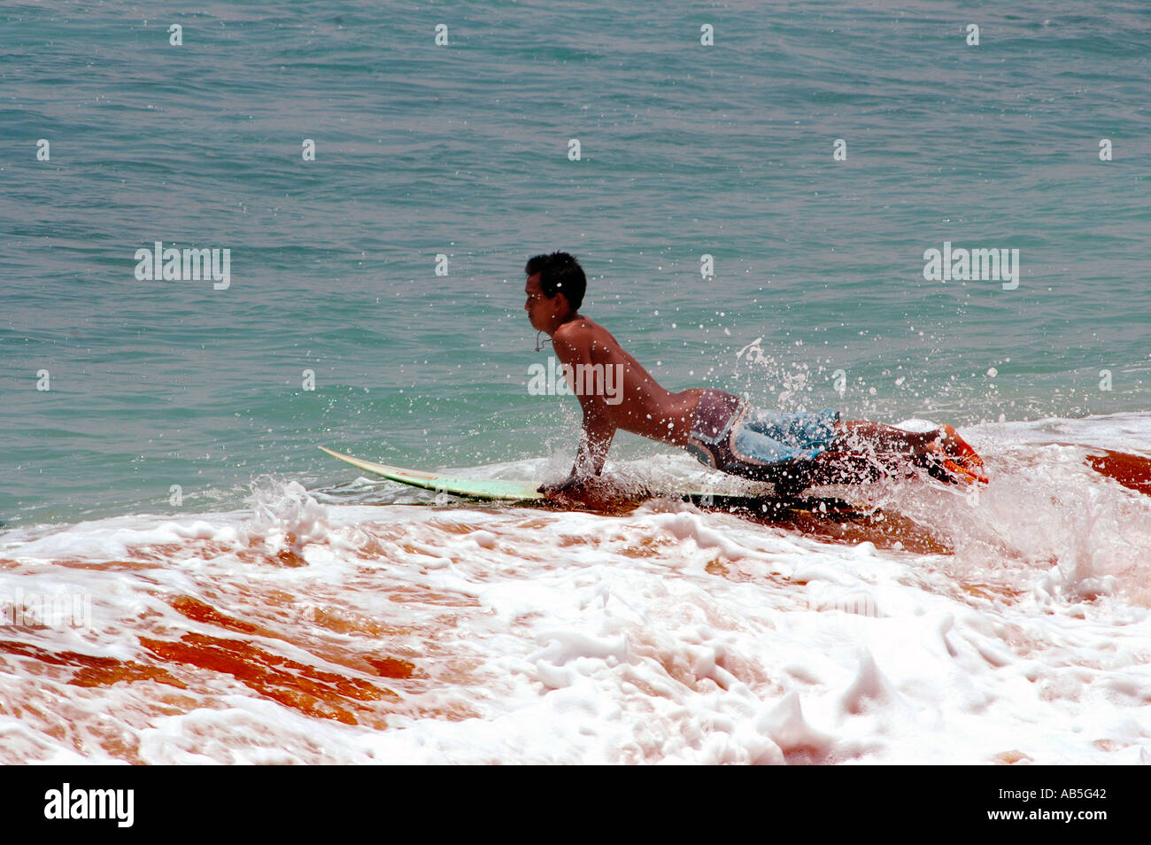 indonesian surfer entering the water after tsunami Stock Photo - Alamy