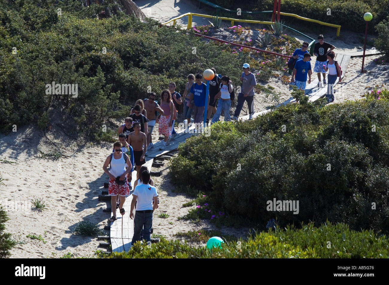 people in single file on the beach Stock Photo - Alamy