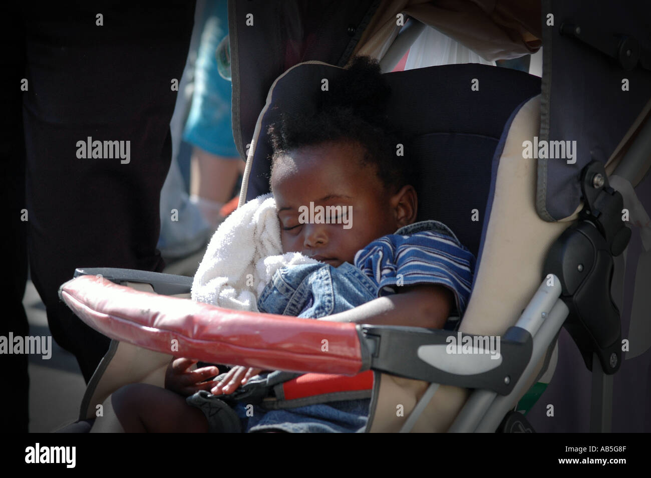 african child sleeping on pushchair Stock Photo - Alamy
