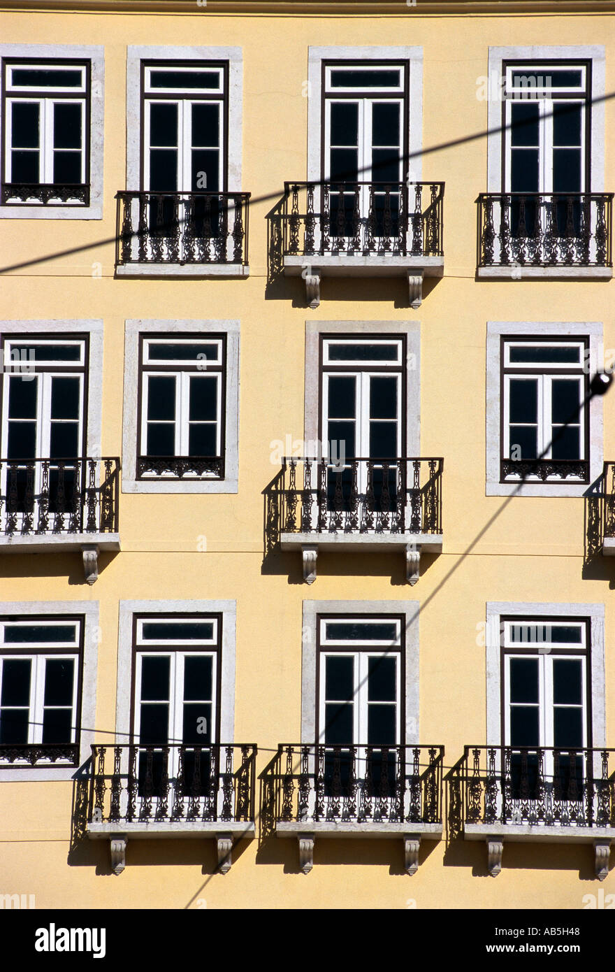 yellow building with many windows Stock Photo - Alamy