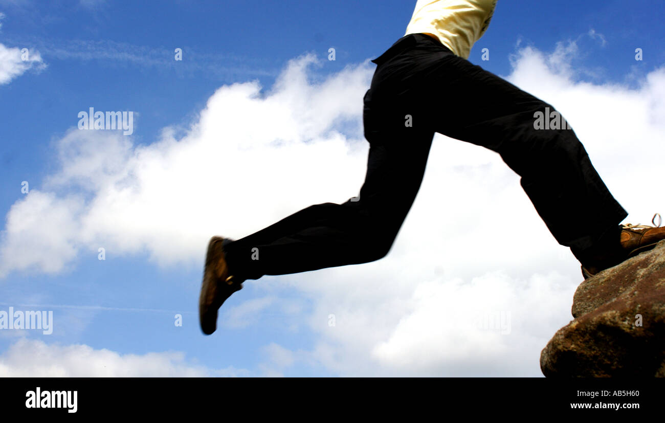 Girl jumping across rocks hi-res stock photography and images - Alamy