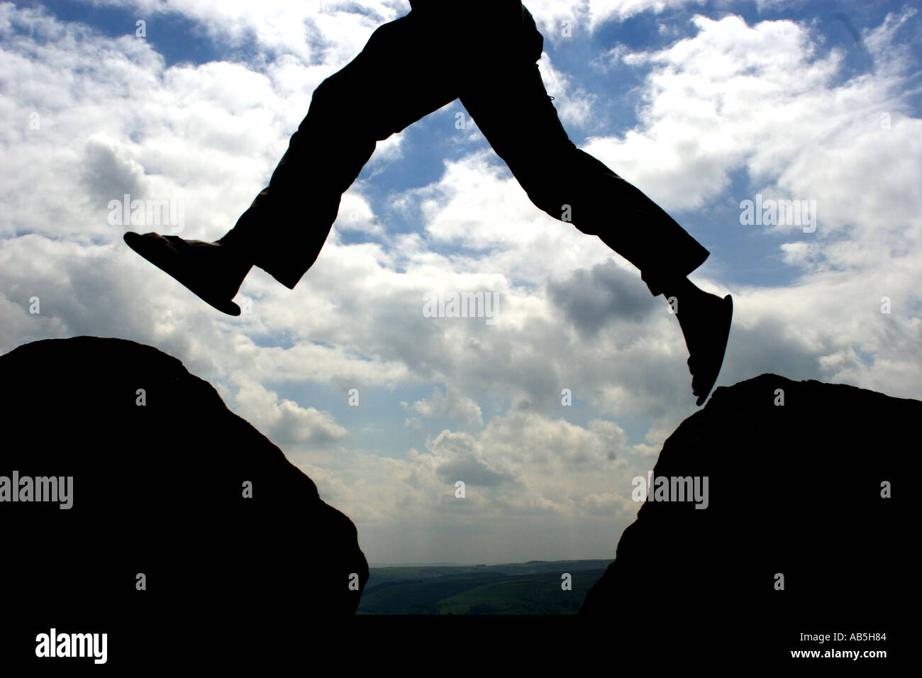 jumping between two rocks Stock Photo - Alamy