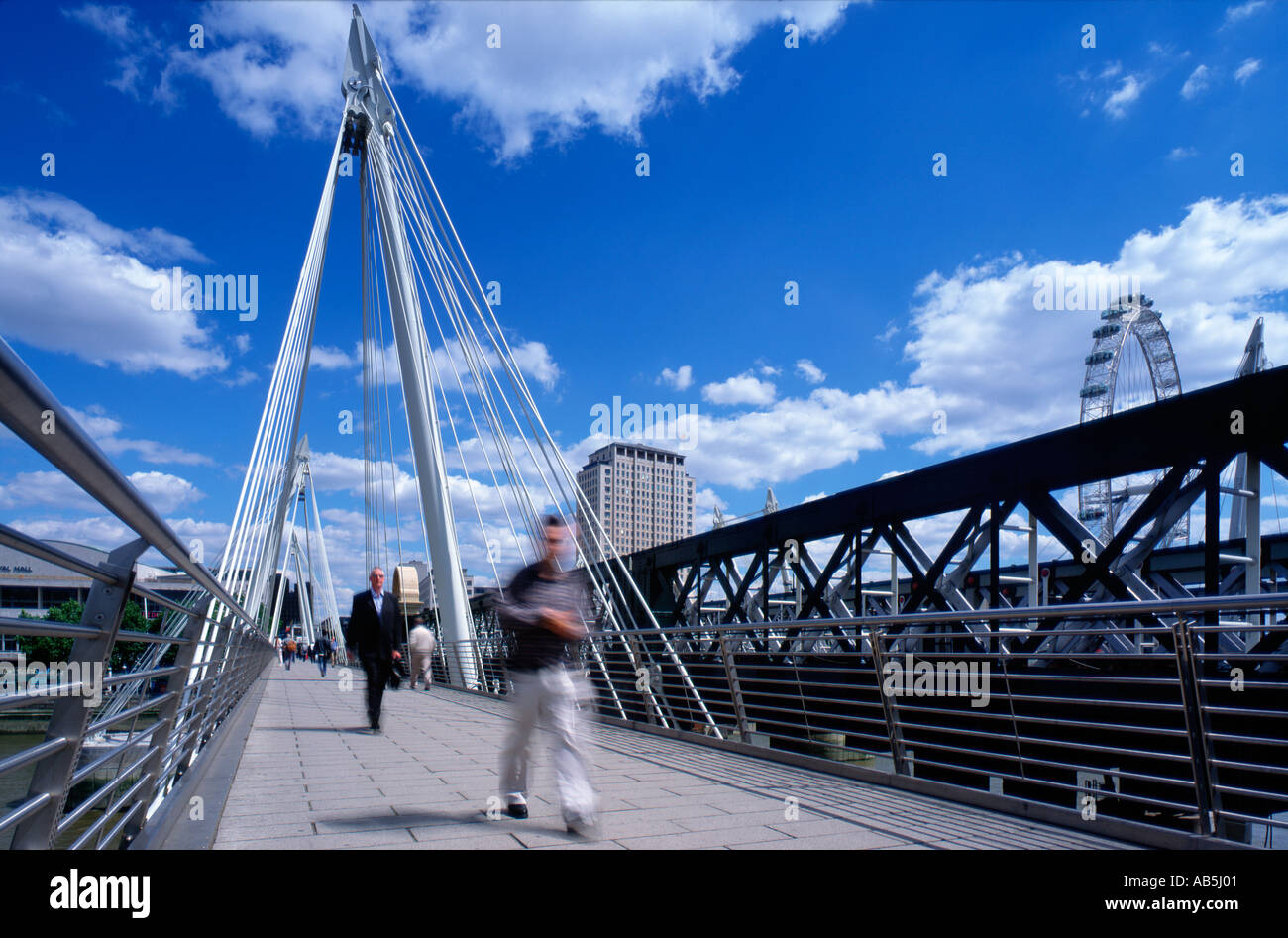 Office Workers cross Hungerford Footbridge over river thames London uk ...