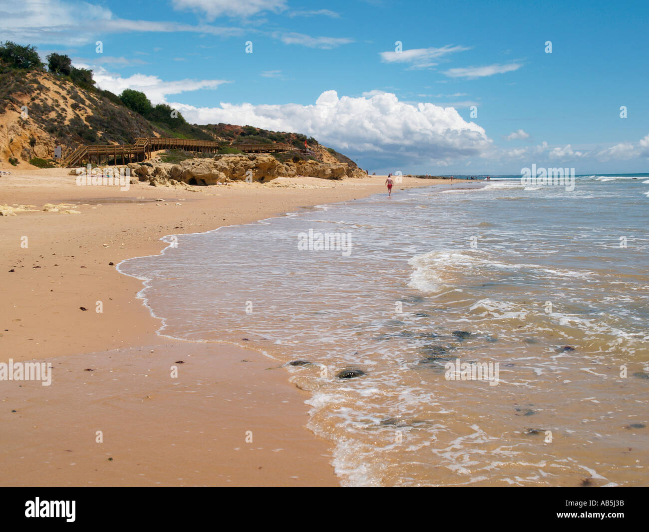 PRAIA DA OURA quiet sandy beach surrounded by sandstone cliffs with a ...
