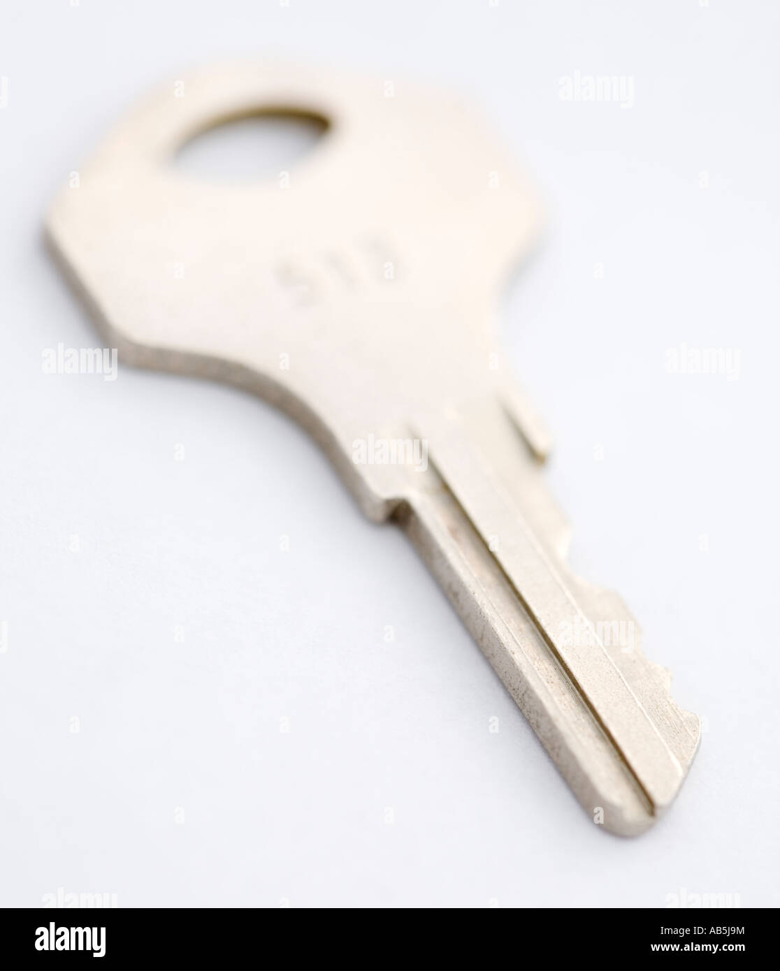 Ordinary small key on a bright white background Stock Photo - Alamy