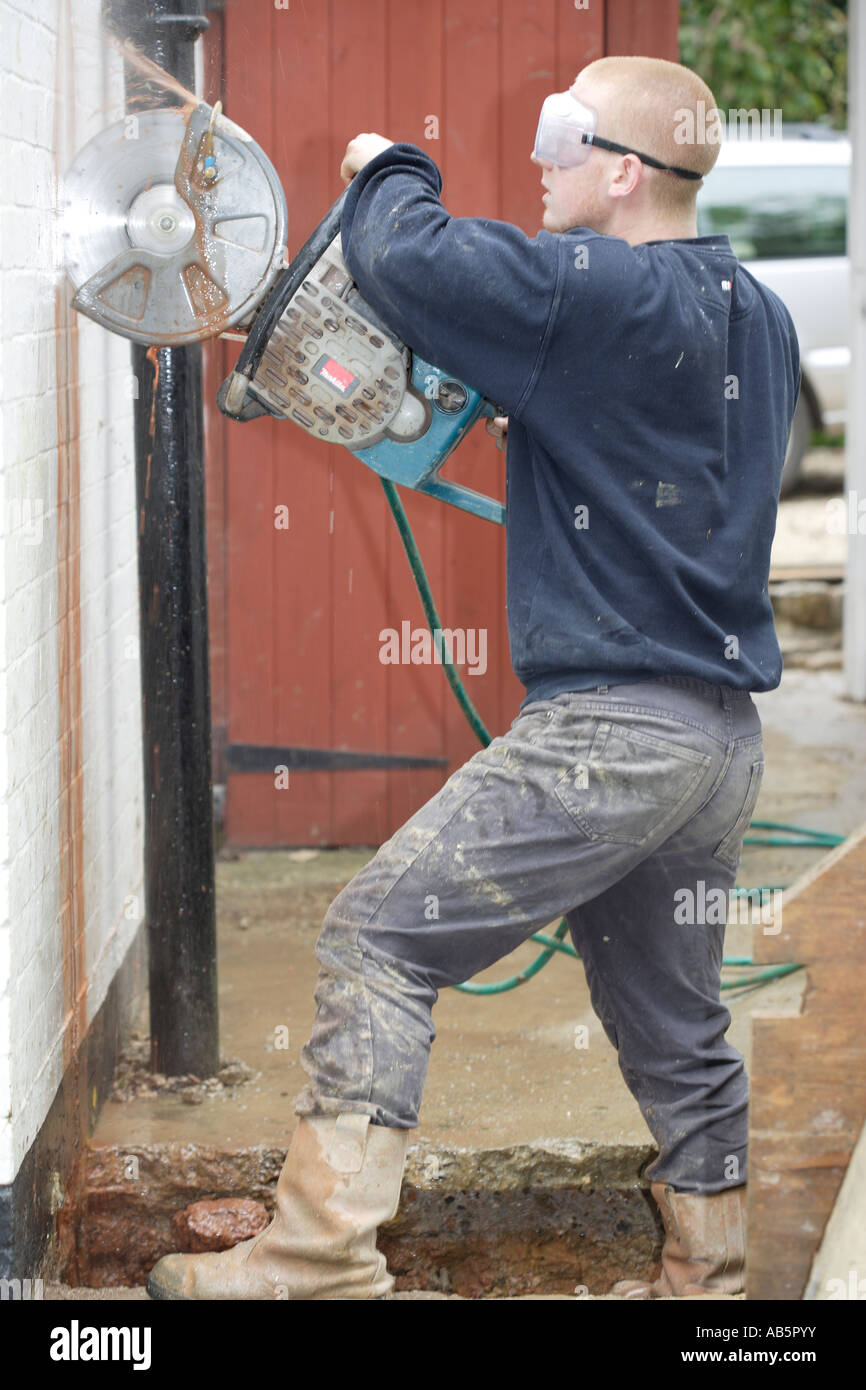 Builder cutting into brickwork with a rotary diamond disc Stock Photo ...