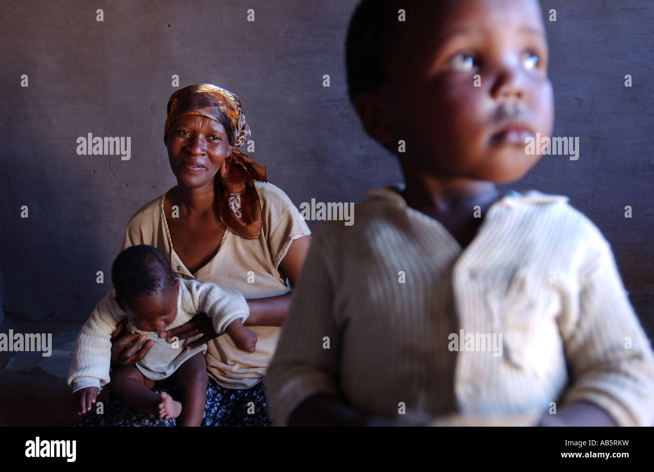 A HIV positive mother with two of her five children in her home in ...