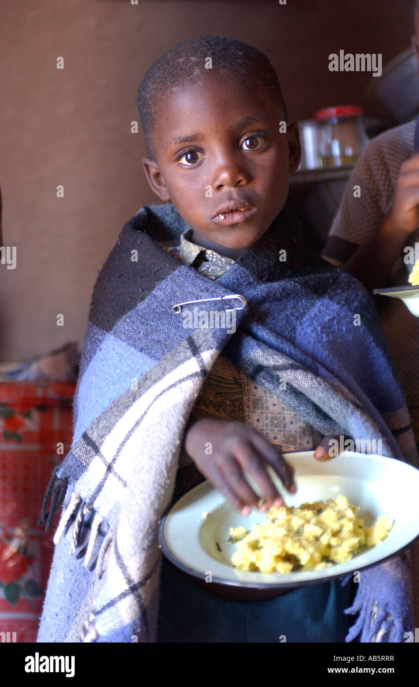 Basotho orphan eats food prepared by his grandmother. Both his parents ...
