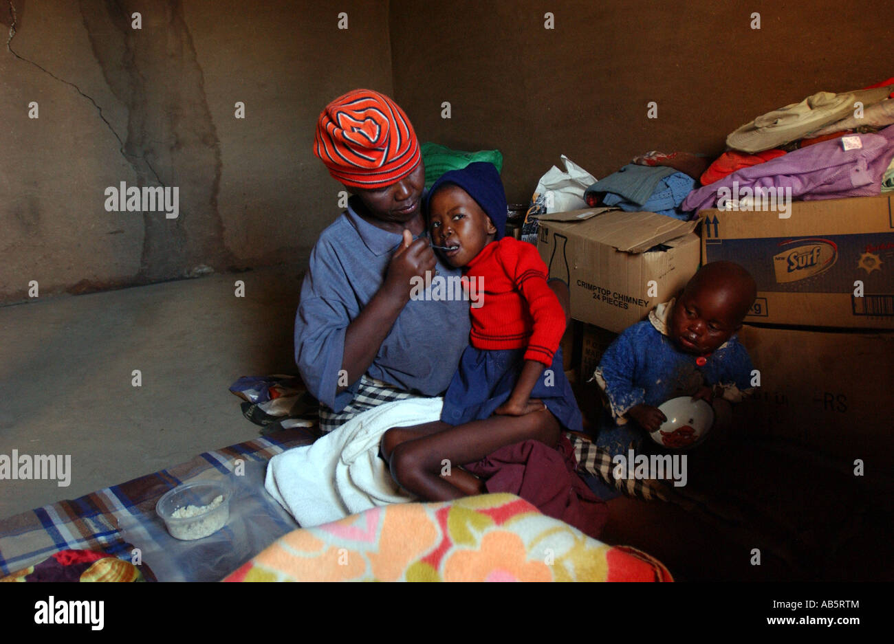 A mother feeds her sick child in Lesotho, Southern Africa Stock Photo ...