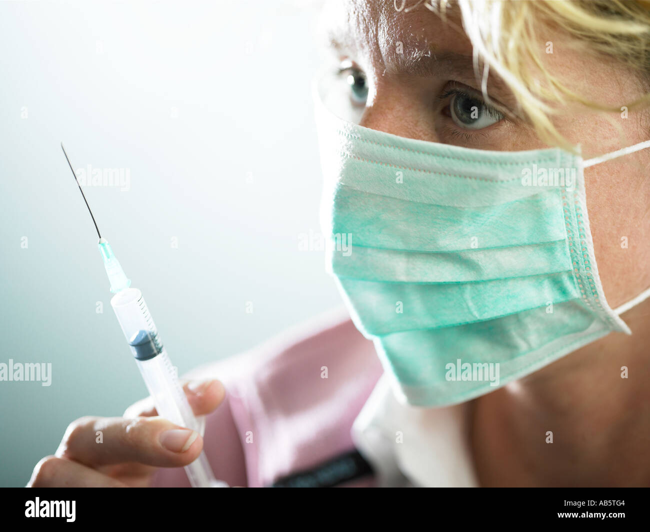a health worker about to administer medication to patient via injection ...