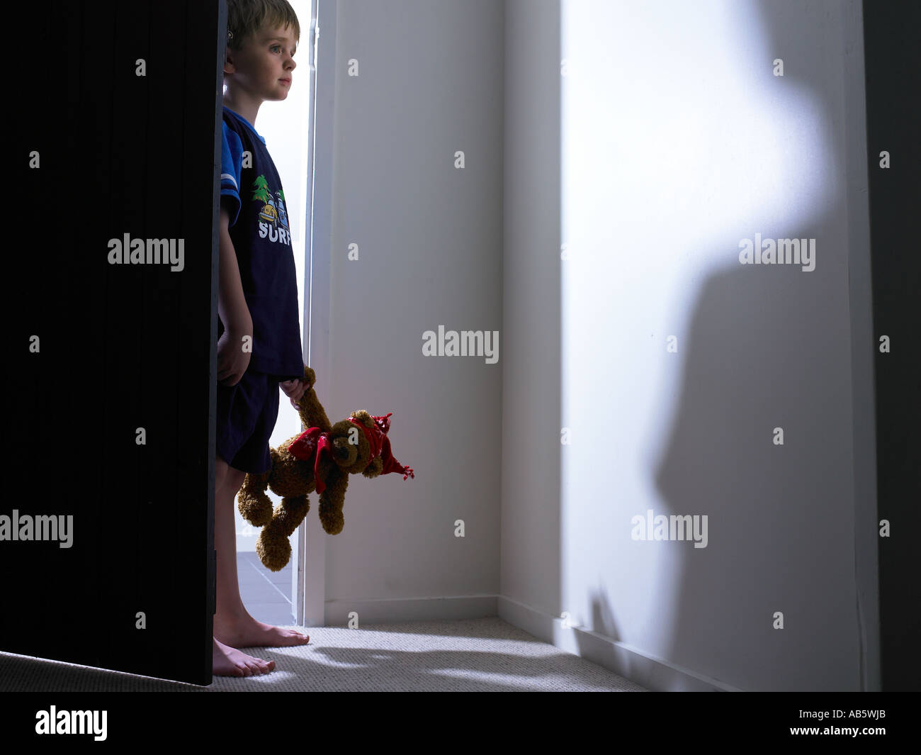 child walking in house at night coming out of the light with ...