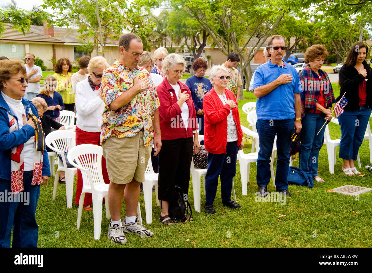 Local citizens cross their hearts while the Pledge of Allegiance is ...