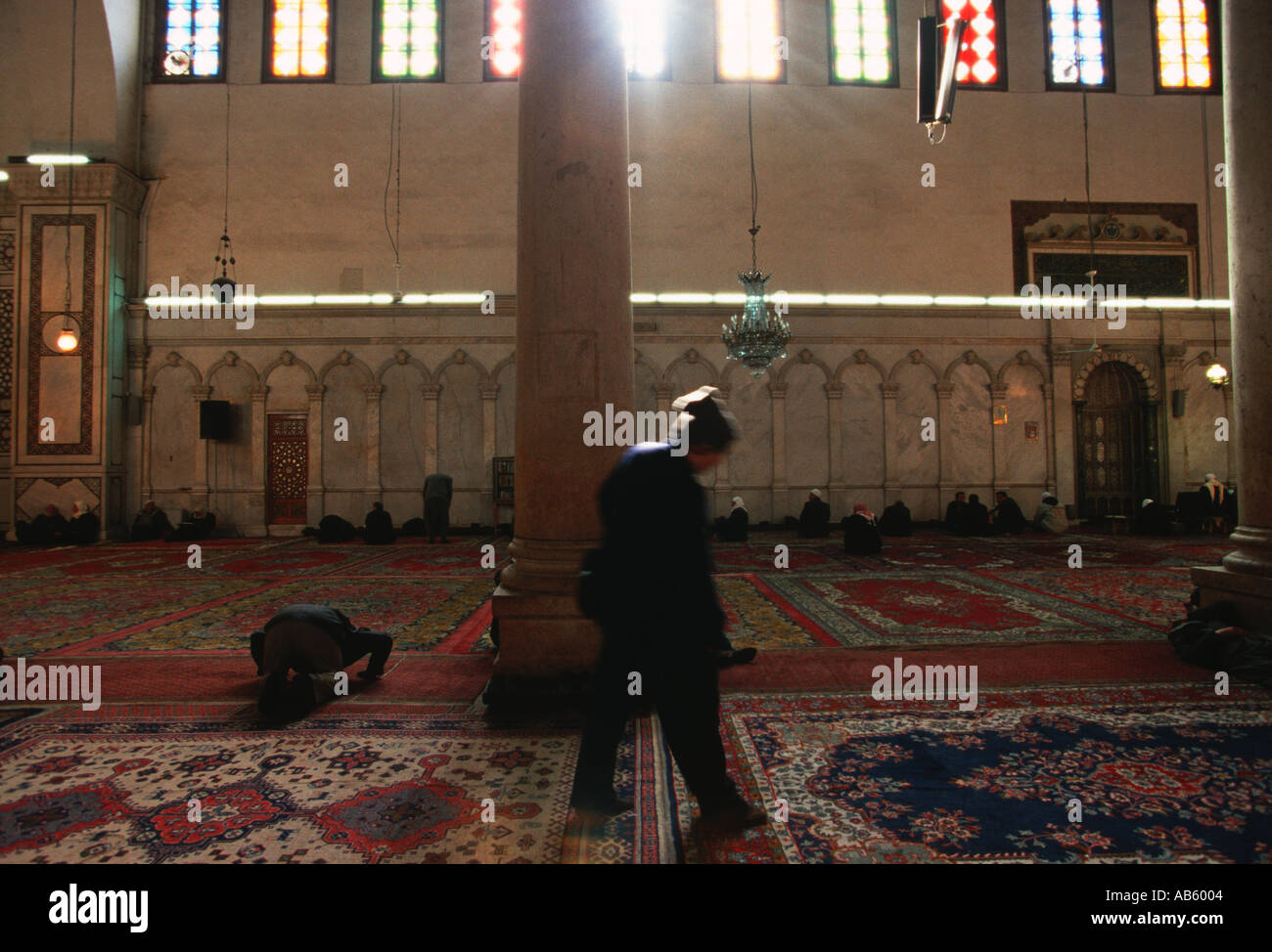 Syria Damascus Man walking past other men at prayer in a mosque Stock ...