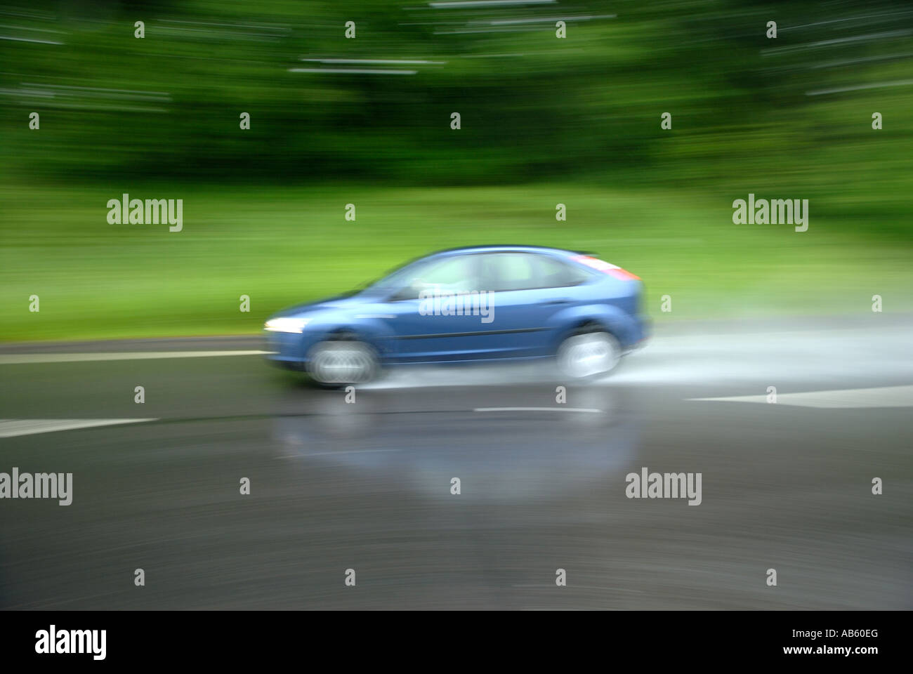 Car on wet road surface Stock Photo - Alamy