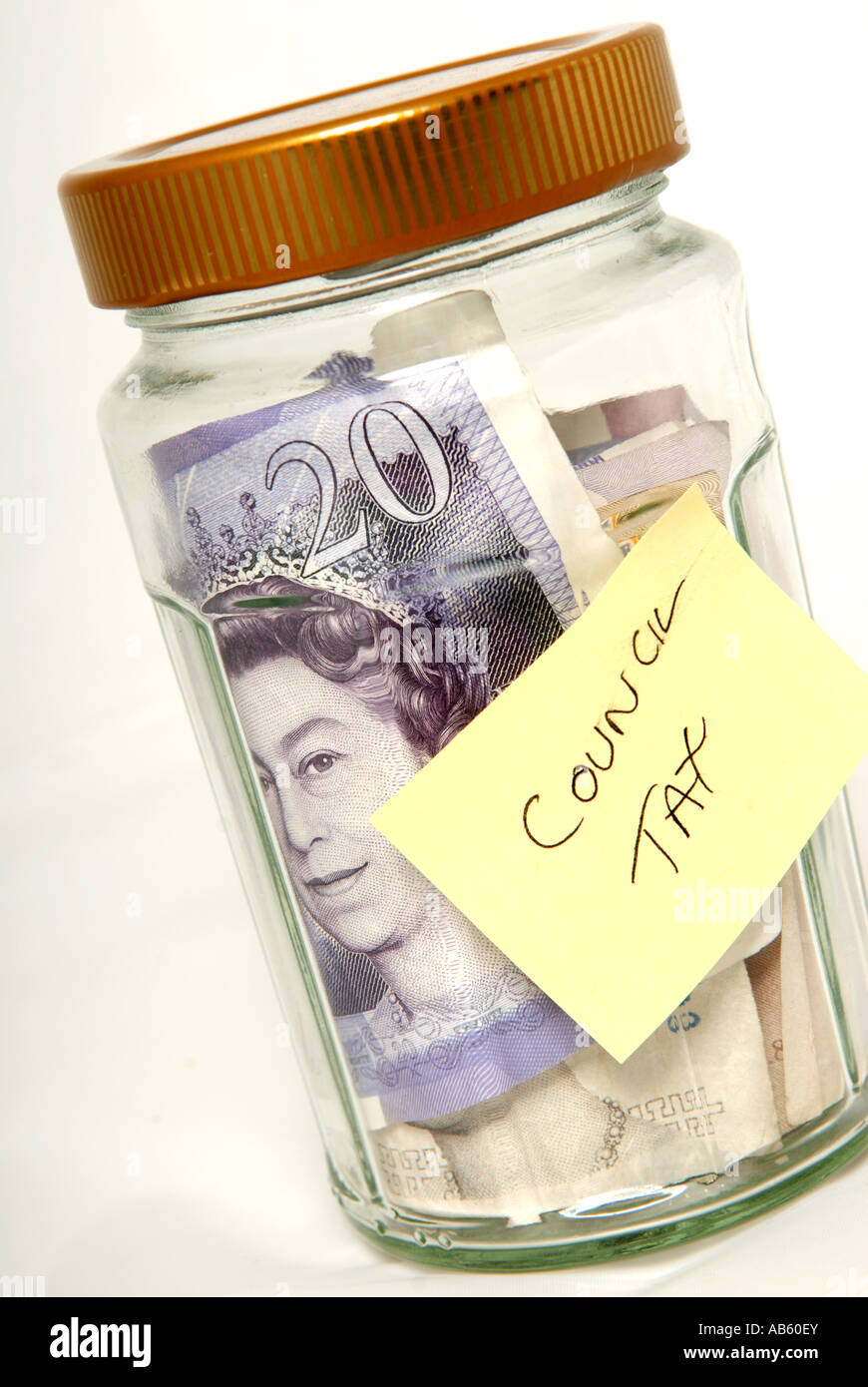 Saving money in jar Stock Photo - Alamy