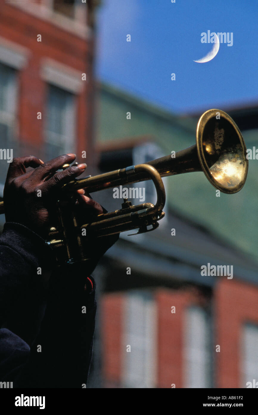 Louisiana New Orleans French Quarter street musician playing trumpet with crescent moon in sky ...