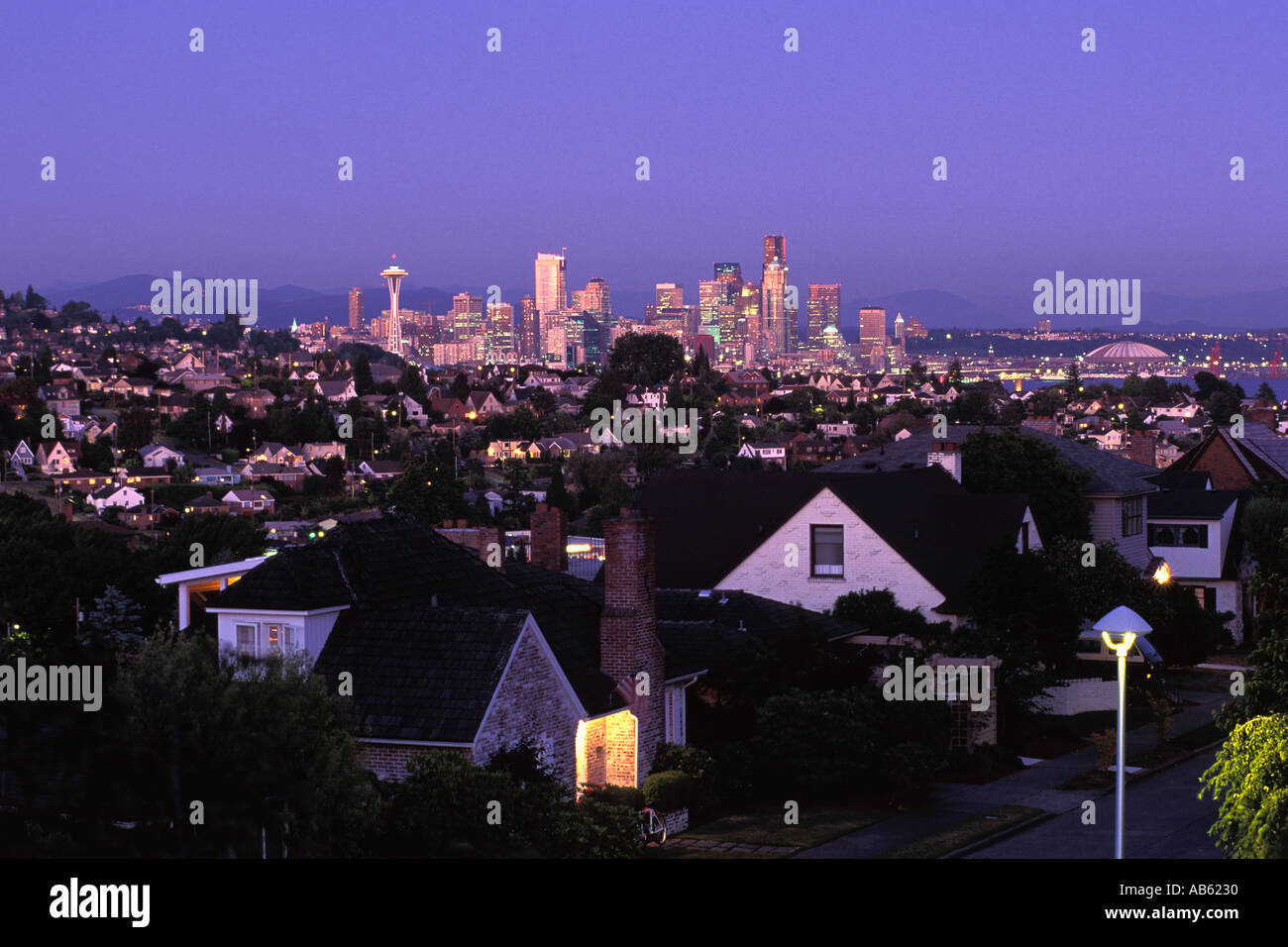Magnolia neighborhood homes and Seattle Washington skyline at dusk ...