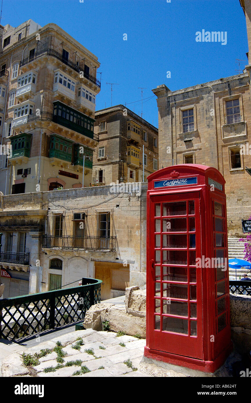 Red British telephone box and traditional buildings in Valletta Malta ...