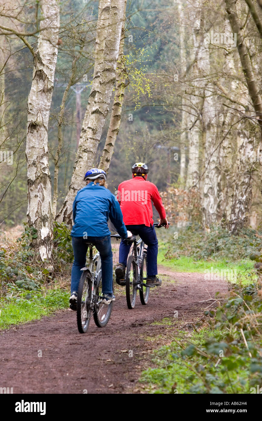 Two people enjoying an outdoor activity, cycling along a path in a ...