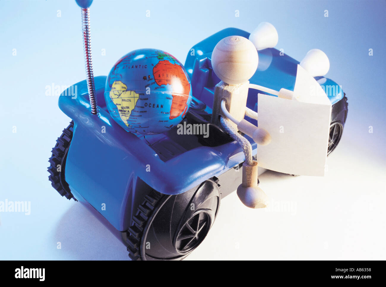 Wooden Figure Reading on Toy Car Stock Photo - Alamy