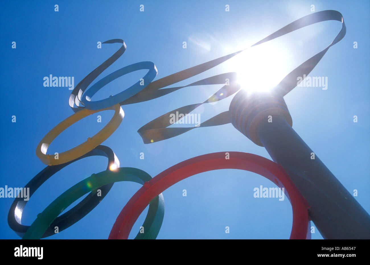 A sculpture of the Olympic Torch, the flame seemingly lit by the sun ...