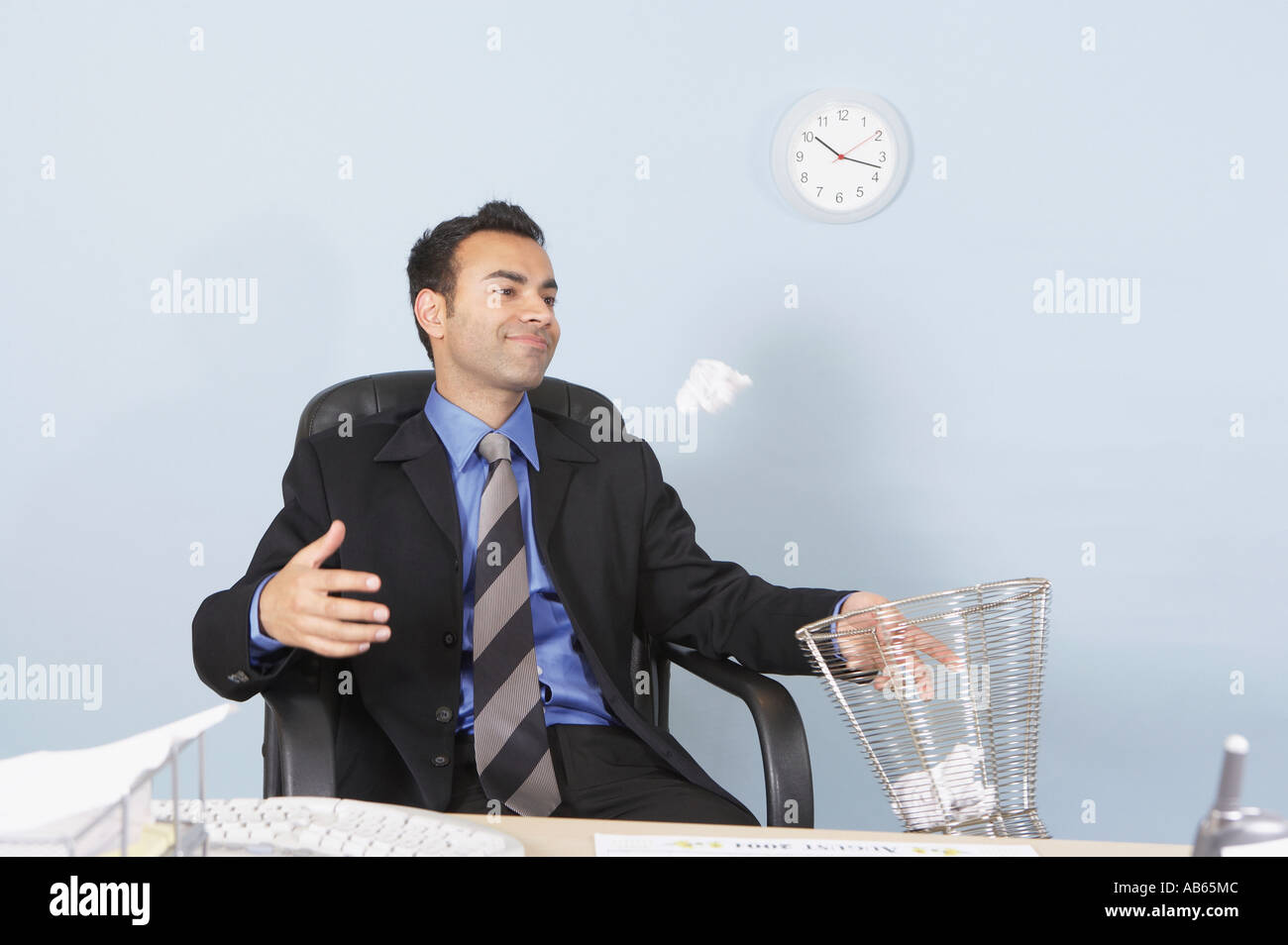 Young businessman throwing trash into a garbage can Stock Photo - Alamy