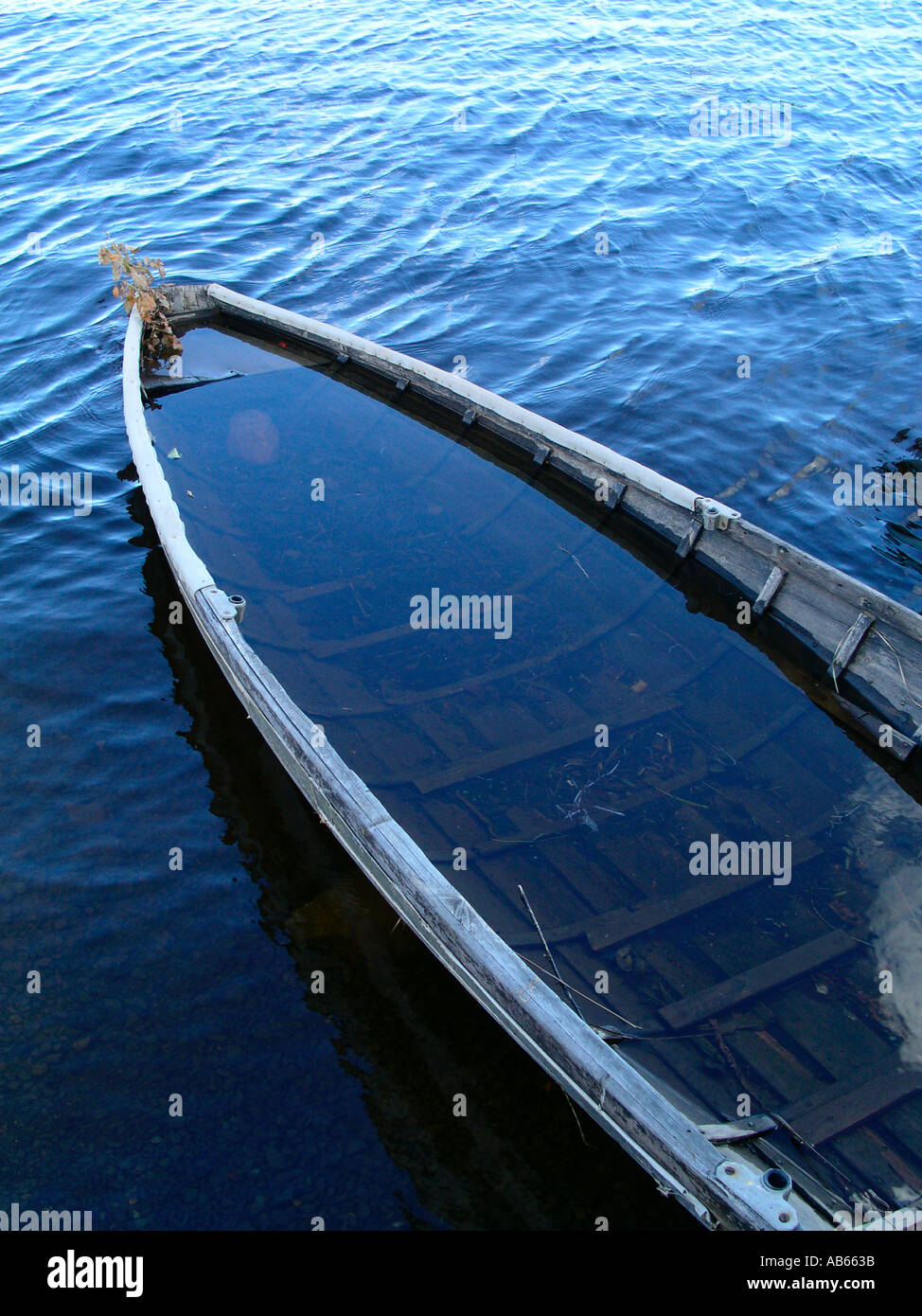 rowing boat filled with water Stock Photo - Alamy