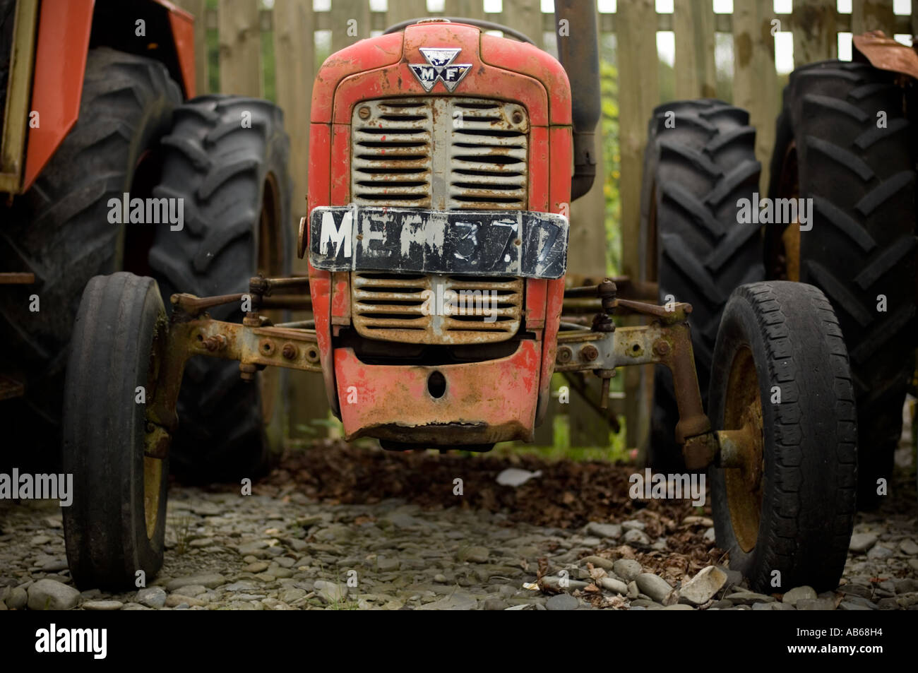 Old rusty tractors lined up in a garage in Llanfarian Aberystwyth ...