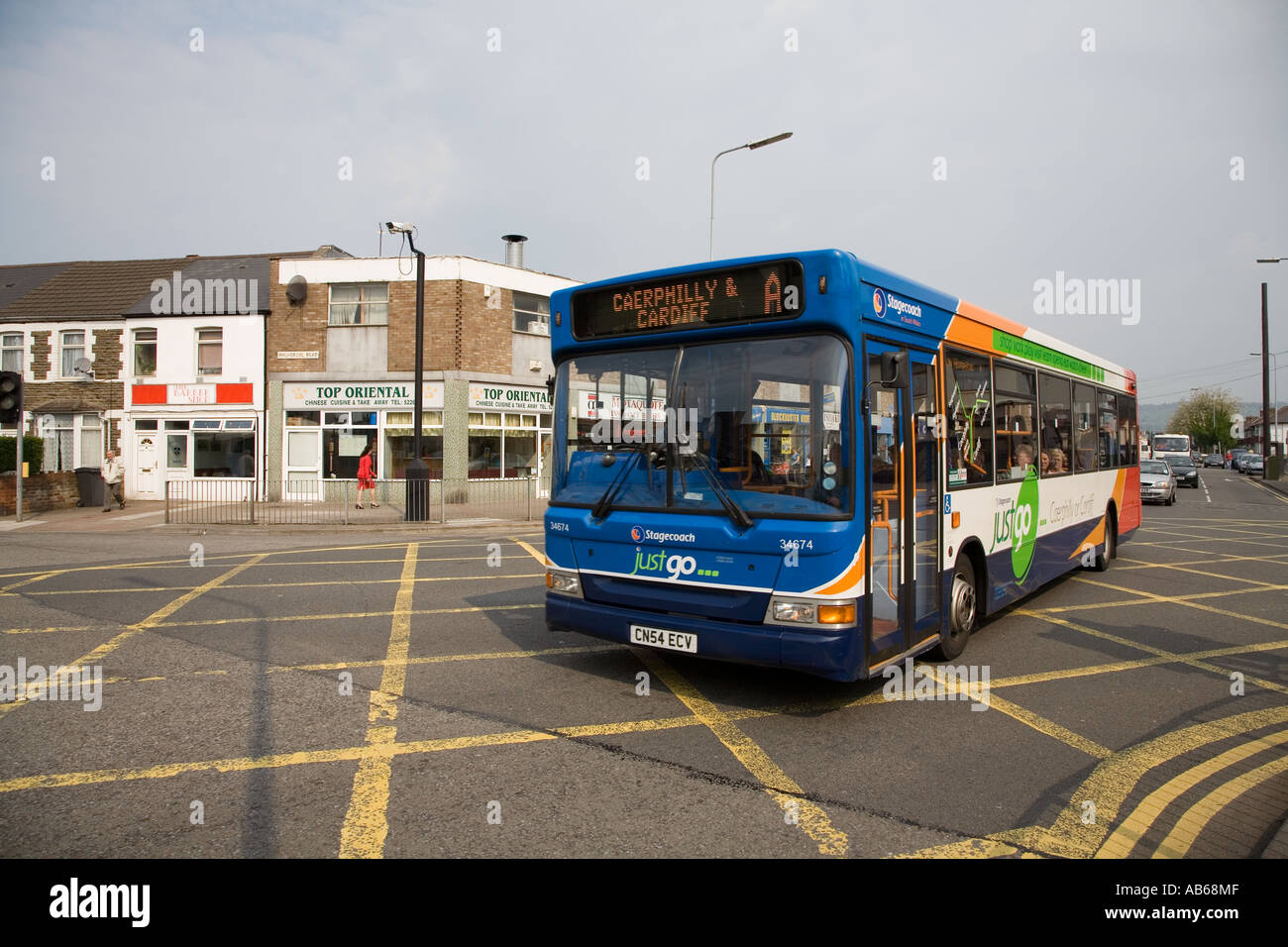Bus and traffic at a busy crossroad intersection with yellow do not ...
