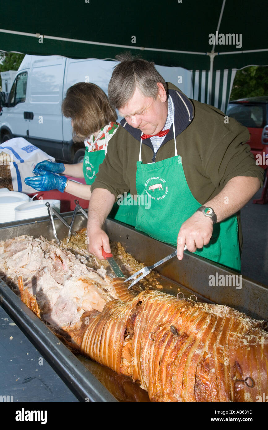 Carving meat from a pig roast at a wedding celebration Wales UK Stock ...