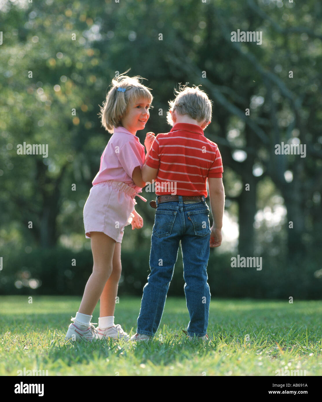small boy and girl exploring park Stock Photo - Alamy