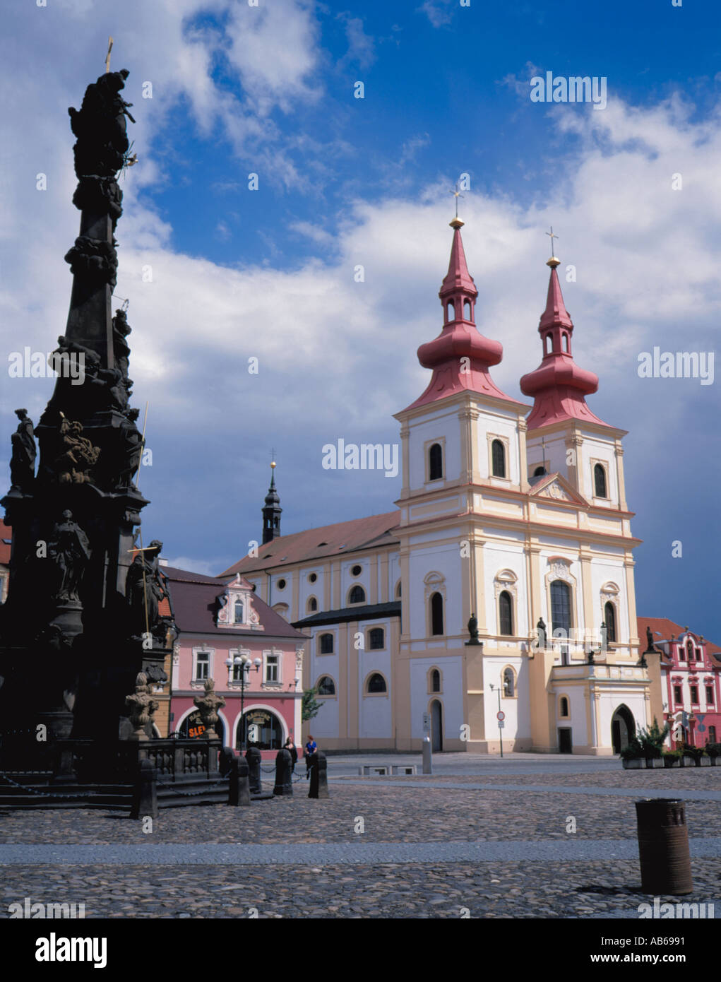 Plague column and beautiful colourful old church seen over the Main ...