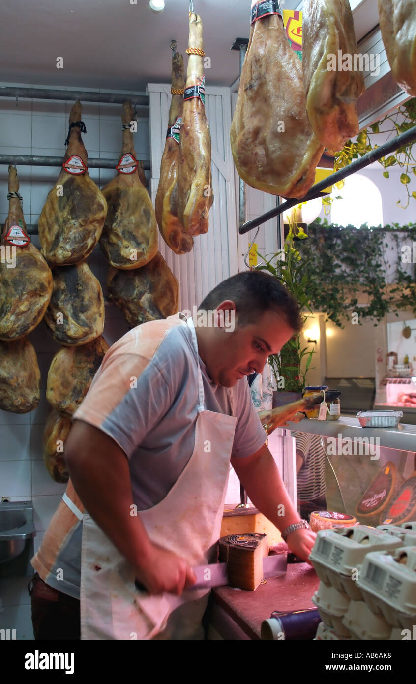 Butcher cutting a Serrano ham Shop in Southern Spain Europe EU Stock ...