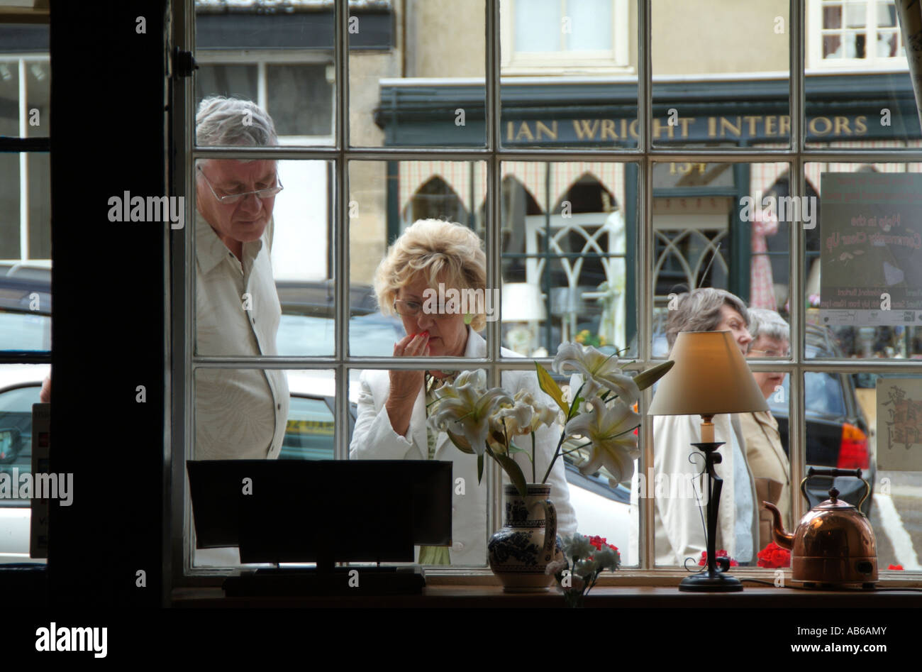 Window shoppers in Burford Oxfordshire England UK Town centre and the ...