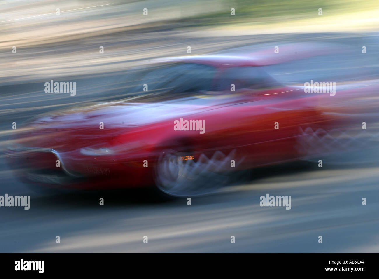 Fast moving red sports car Stock Photo - Alamy
