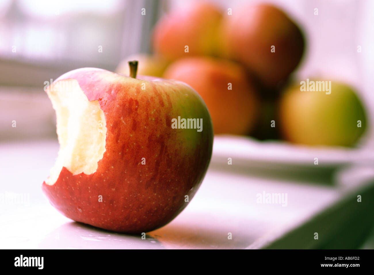 APPLES ON WINDOW SILL WITH ONE APPLE IN FOREGROUND WITH BITE TAKEN OUT ...