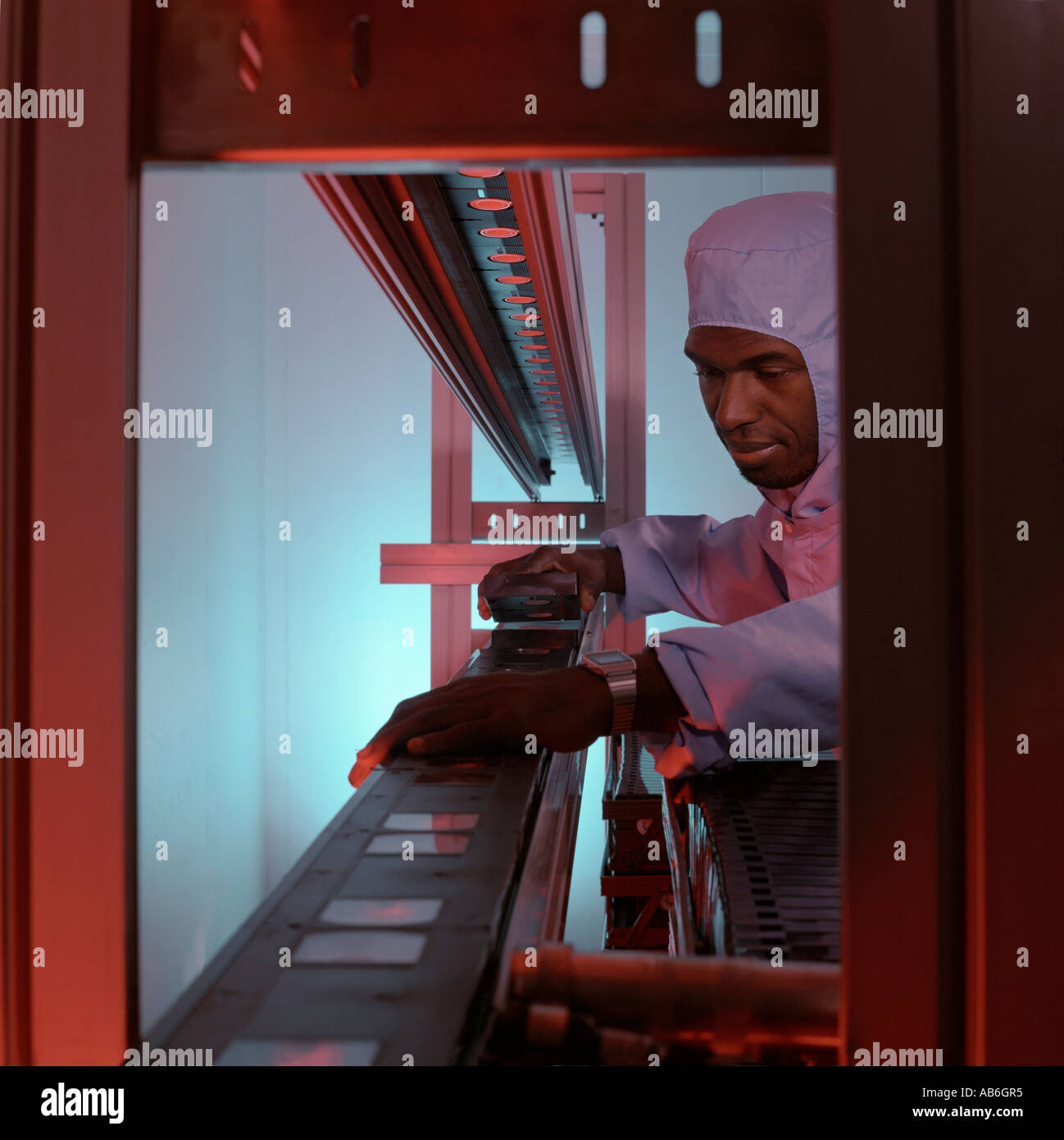 Inspecting video tape in clean room during manufacture Stock Photo - Alamy
