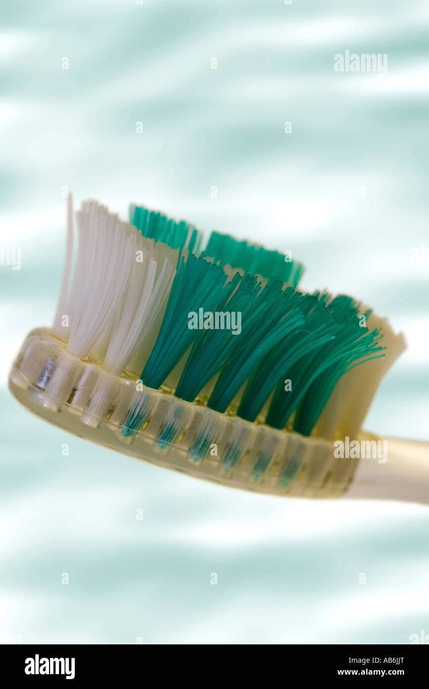 Old worn out toothbrush with ripple effect background Stock Photo - Alamy