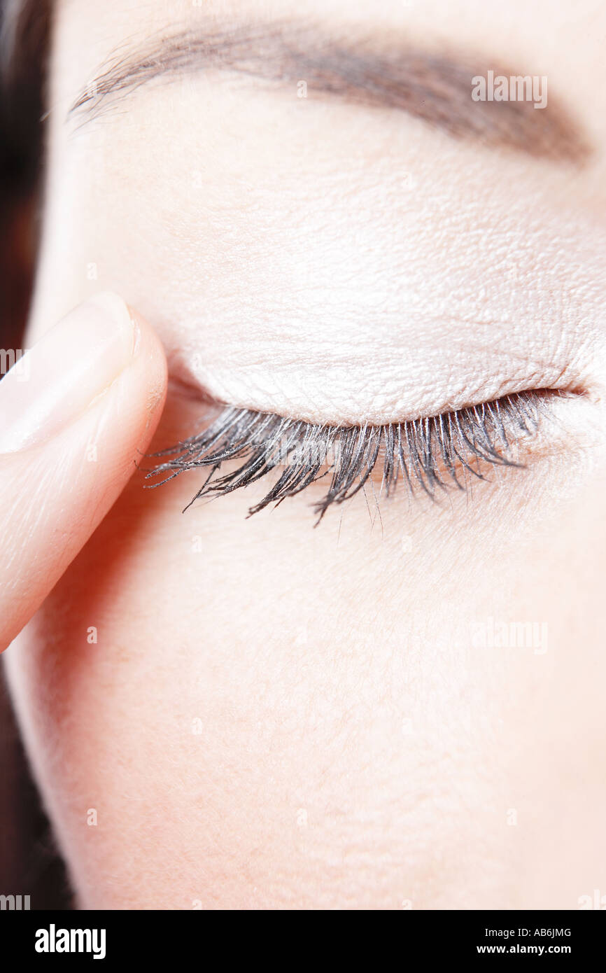 Eye close-up with finger Stock Photo - Alamy
