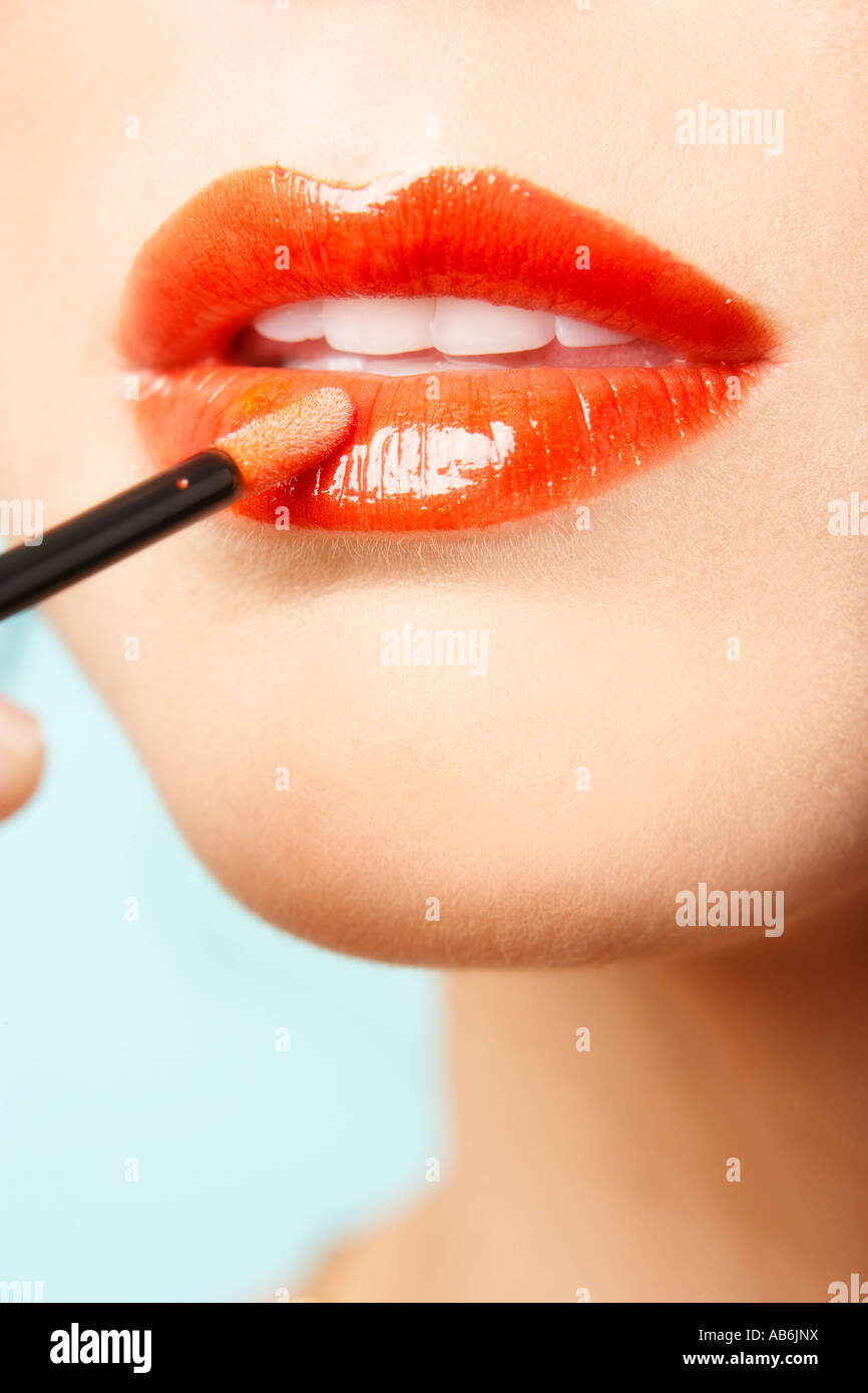 Lips in Close-up applying lipstick Stock Photo - Alamy