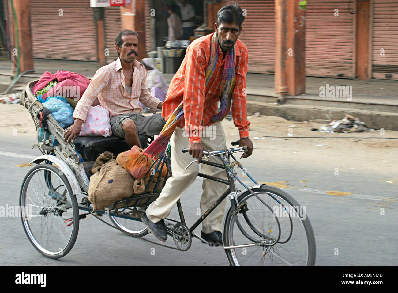 Rickshaw driver with passenger transporting produce to market, Jaipur ...