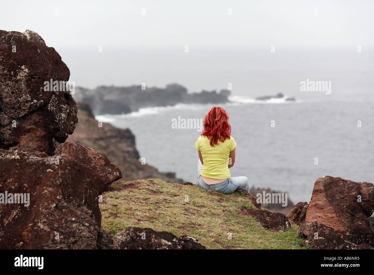 Young woman overlooking ocean on the northern shore of Maui, Hawaii ...