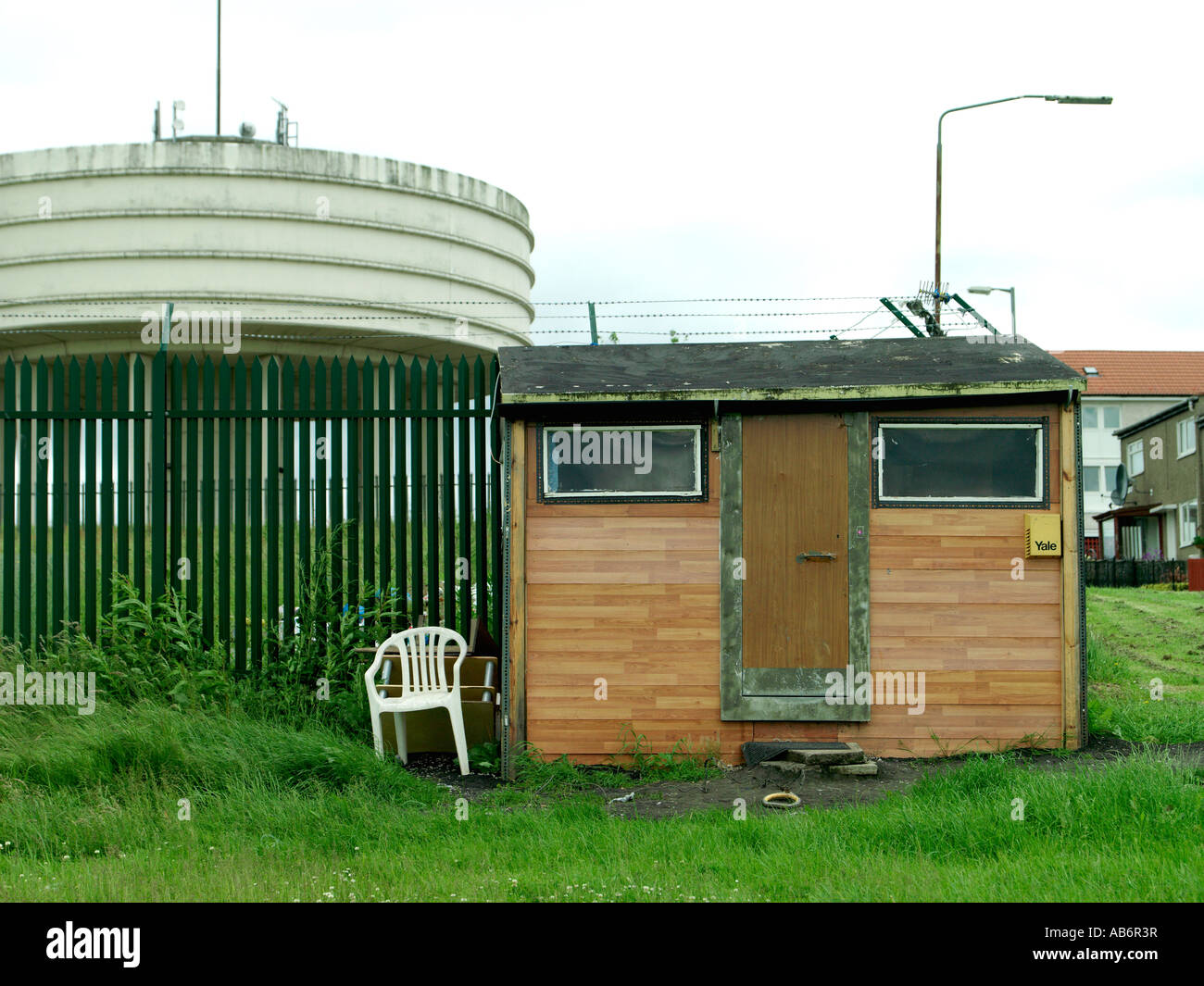 Wooden hut in front of water tower Stock Photo - Alamy
