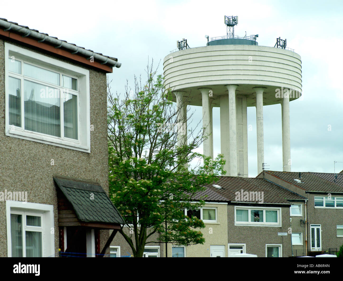 Water tower behind houses Stock Photo - Alamy