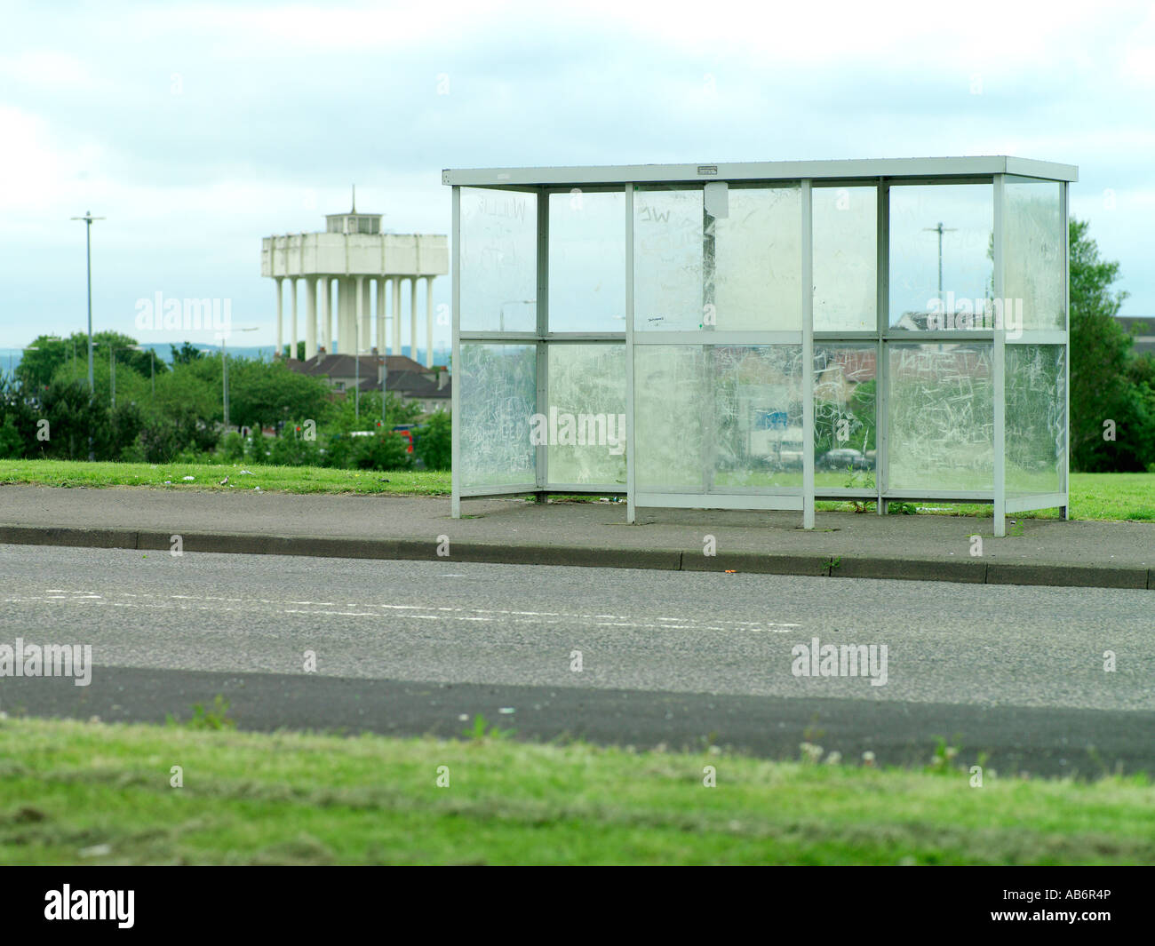 Bus stop with shelter and water tower in the distance Stock Photo - Alamy