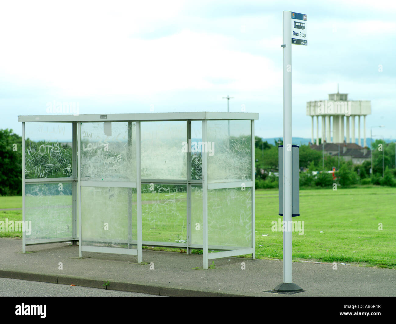Bus stop with shelter and water tower in the distance Stock Photo - Alamy