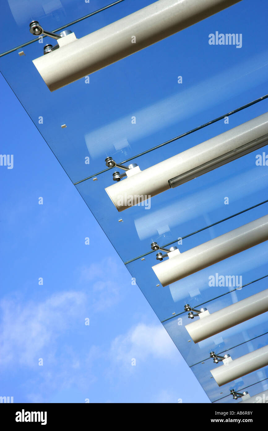 architectural detail of glass sheet canopy supported by white columns ...