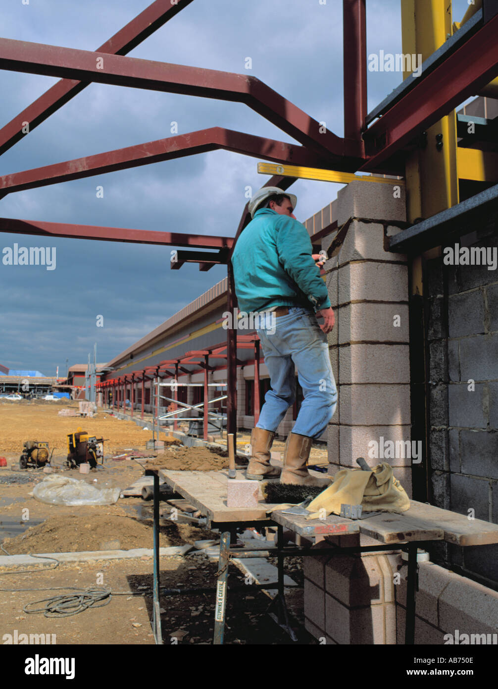 Workman laying blockwork on a building site, Teesside Park, Stockton-on ...